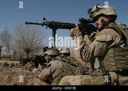 Soldiers take cover behind a berm after making contact with the enemy ...