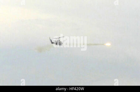 A US Marine Corps (USMC) AH-1W Super Cobra helicopter engages an enemy ...