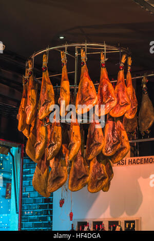 Jamon (ham) hanging on a shop in La Boqueria, the famous food market ...