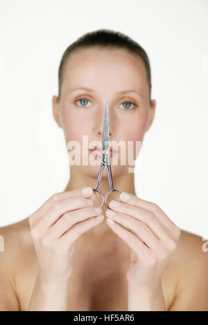 Female person hands holds scissors and green polymer clay, master at ...