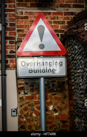 Warning road sign for overhanging building and balcony in town of ...