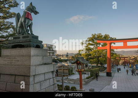 Kitsune, the god rice fox messenger statue in fushimi inari shrine near ...