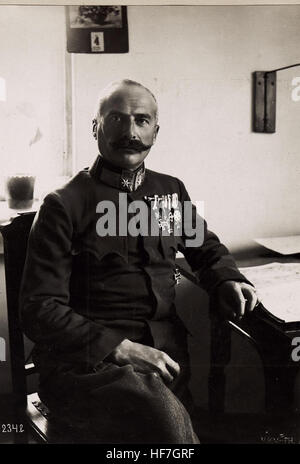 This historical photograph depicts a German officer studying a map ...