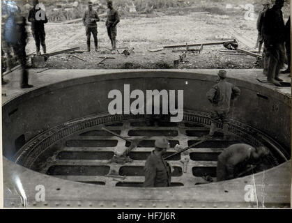 This historical image depicts a 42 cm howitzer in position during World ...