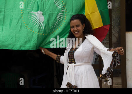 A woman holds the African Union and Ethiopian flags during the ...