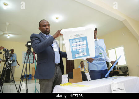 Officials of the Union Election Commission prepare to close a polling ...