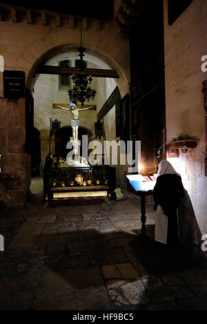 A Russian Orthodox nun reading the bible at the basement where remnants ...