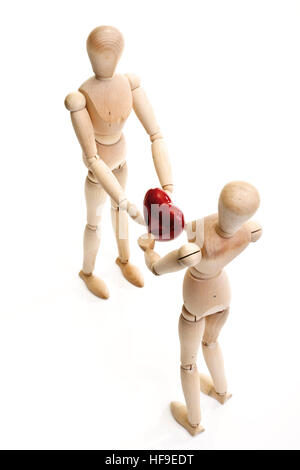 Male and female jointed mannequins with heart: giving away your heart ...