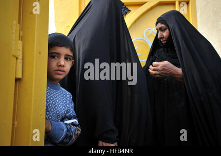 Iraqi families receive cows at a school in Abu T'Shir, Baghdad, as part ...
