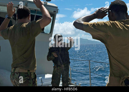 Seychelles Coast Guard boarding team members depart from a simulated ...