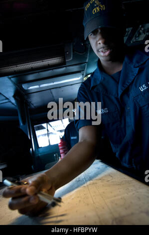 A Quartermaster aboard USS Carl Vinson (CVN 70) plots the ship’s ...