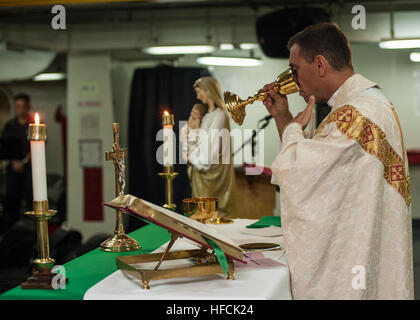 A French military chaplain presides over a Catholic Mass aboard the ...