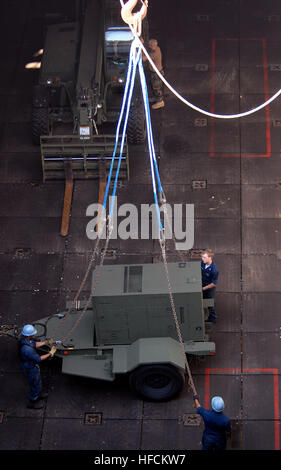 Petty Officer 1st Class Leslie Cleaver directs the aircrew in the ...