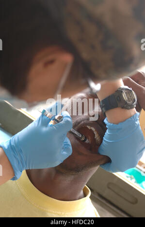 A Marine with Combined Joint Task Force (CJTF) gets assistance putting ...
