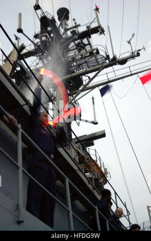 US Navy A Signalman uses semaphore to communicate via hand signals with ...