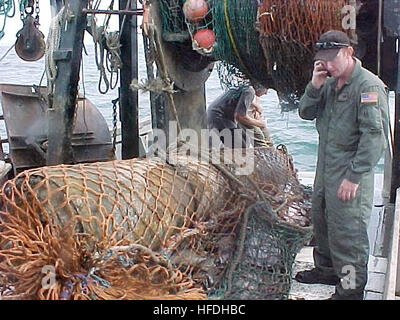 WORLD WAR II: TORPEDO NET. /nA U.S. Navy ship laying an anti-torpedo ...