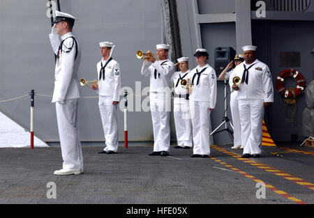 US Navy The Chief of Ceremonies renders a hand salute as one of the ...