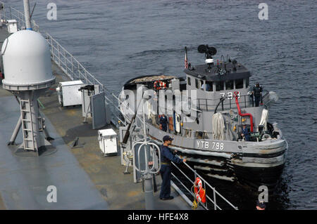 The large harbor tug OPELIKA (YTB-798) pulls up along the starboard ...