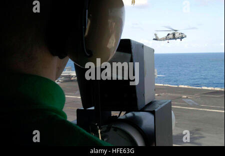 US Navy A Sailor videotapes an SH-60B Seahawk using a Pilot's Landing ...