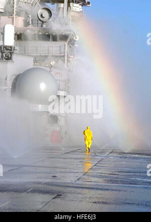 US Navy A rainbow forms as a Sailor makes a final check of the ...