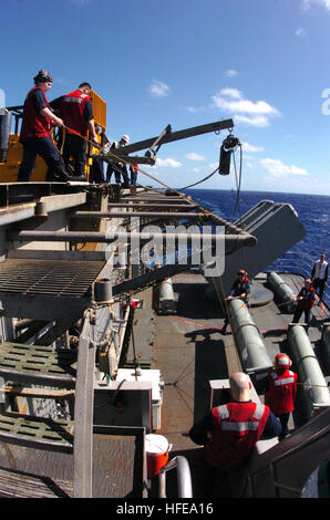 US Navy Fire Controlmen prepare to load a RIM-7 NATO Sea Sparrow ...