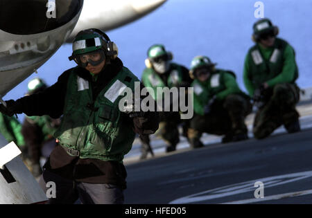 US Navy A top-side safety petty officer directs an E-2C Hawkeye ...