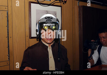 US Navy Jackie Chan tries on a fighter pilot's helmet with night vision ...