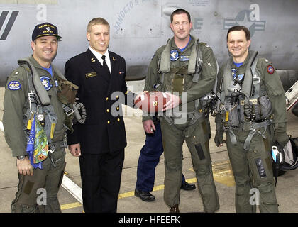 US Navy Naval Academy Quaterback Craig Candeto presents the game ball ...