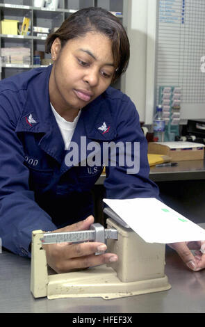 US Navy Postal Clerk 2nd Class logs in an incoming parcel as the ...