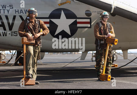 US Navy Plane captains stand by as their aircraft is launched during ...