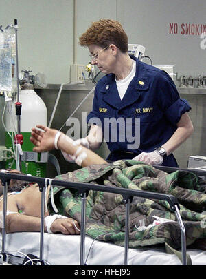 US Navy Cmdr. Linda Nash, Nurse Corps, evaluates an Iraqi patient in ...