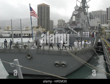 Crew members aboard the frigate USS WHIPPLE (FF-1062) stand at the ship ...