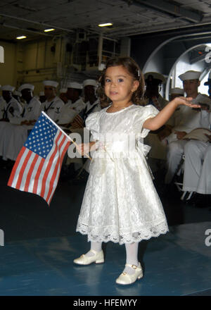 US Navy Store Keeper 3rd Class uses a forklift to transport bedding ...