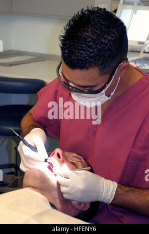 US Navy Dental Technician 2nd Class searches for a patient's dental ...