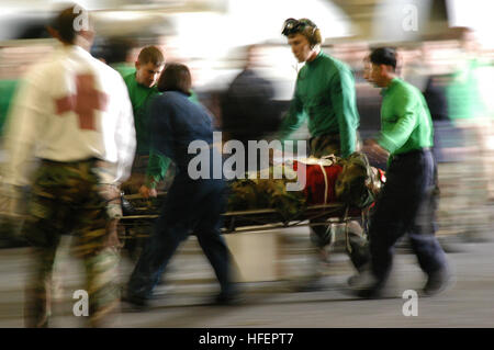 US Navy Repair locker stretcher bearers carry simulated injured ...