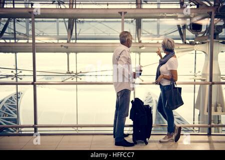 Senior couple traveling airport scene Stock Photo - Alamy