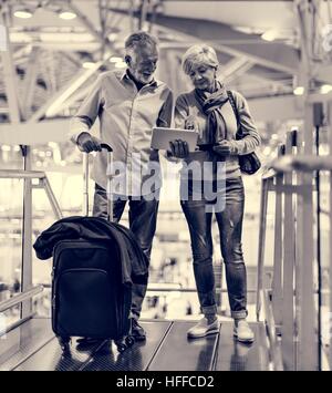 Senior couple traveling airport scene Stock Photo - Alamy