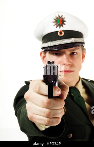 Uniformed police officer aiming pistol tactical firearms training ...