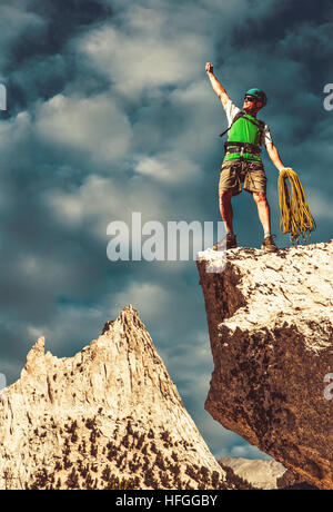 Male climber celebrates on the summit Stock Photo - Alamy