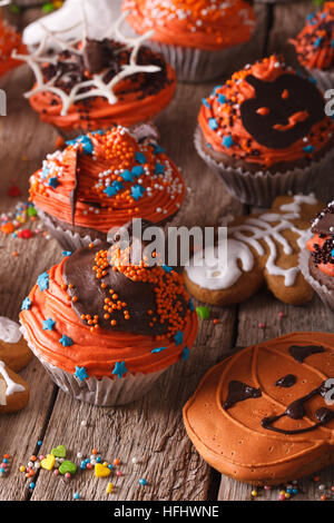 Cupcakes, decorated with icing and sprinkles on a black serving dish ...