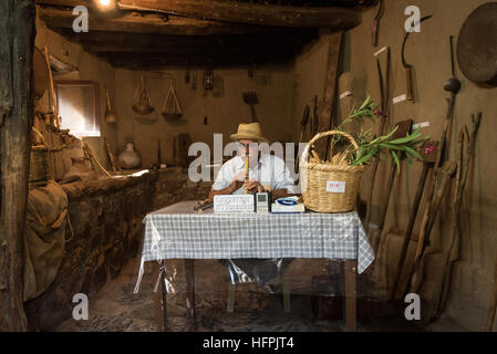 Senior man crafting and playing a handmade cyprus traditional music ...