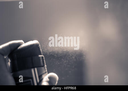 Photograph of a human hand holding an atomizer Stock Photo - Alamy