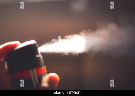 Photograph of a human hand holding an atomizer Stock Photo - Alamy