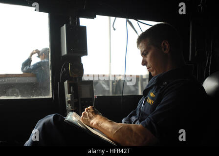 U.S. Navy Cmdr. David Haas uses a rowing machine to work the same ...