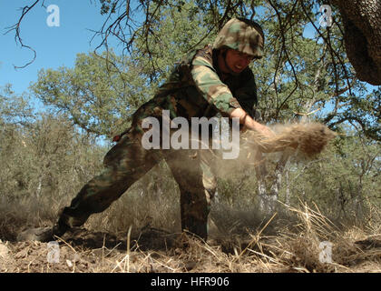 US Navy Builder Constructionmen digs a fighting position along the ...