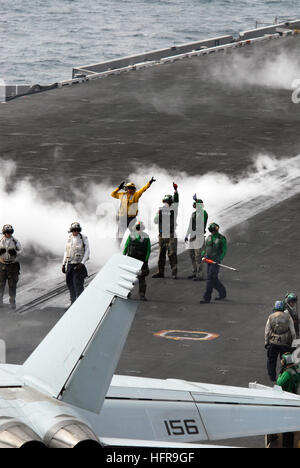 US Navy Aircraft handlers direct aircraft to the number two catapult ...