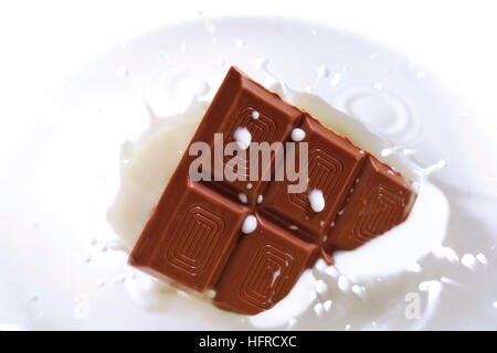 Chocolate falling into Milk Chocolate Stock Photo - Alamy