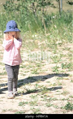 Caucasian kid girl crying alone outside Stock Photo - Alamy