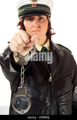 Police officer woman holding handcuffs on a palm tree lined street ...