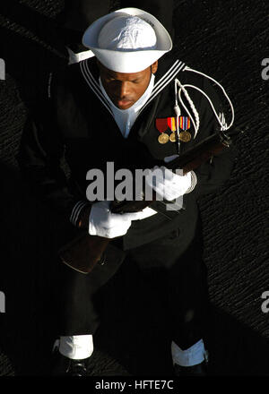 Two naval officers render a salute during a change-of-command ceremony ...